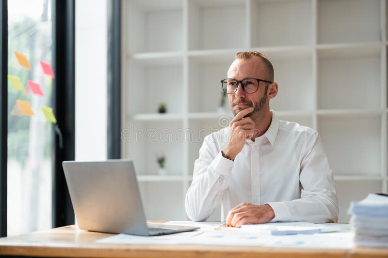 Image of Young Businessman Analyzing Work Using a Laptop at Office Stock Image - Image of ...