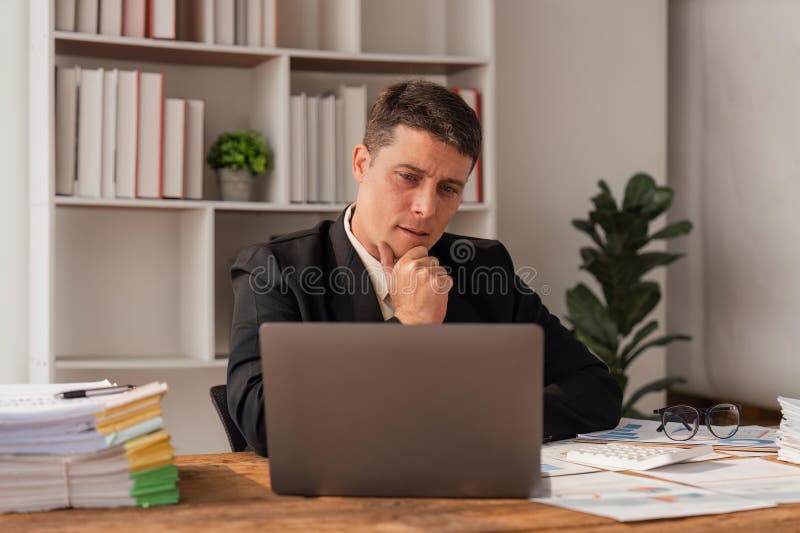 Image of Young Businessman Analyzing Work Using a Laptop at Office Stock Photo - Image of ...