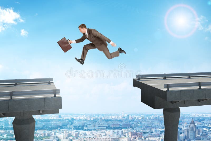 Image of Young Businessman Jumping Over Gap Stock Photo - Image of ...