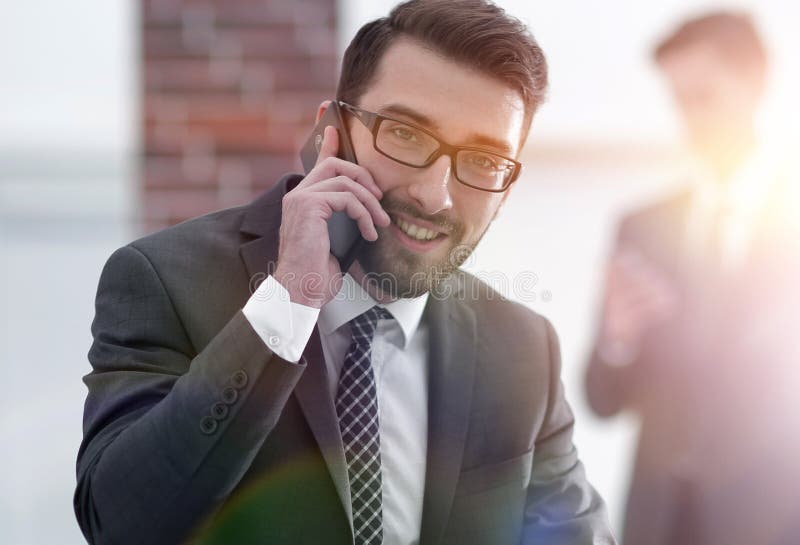 Image of Young Businessman Talking on Mobile Phone with Clients Stock ...