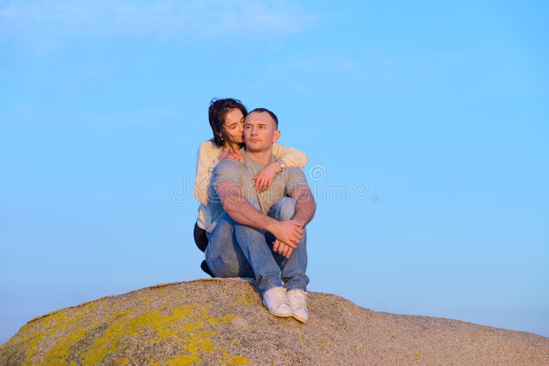 Young Couple in Love on a Cliff Against the Blue Sky Stock Photo ...