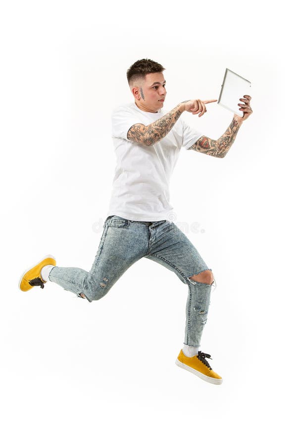 Image of Young Man Over White Background Using Laptop Computer while ...
