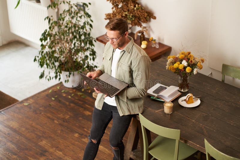 Image of Young Man, Successful Businessman Sitting on Table, Looking at ...
