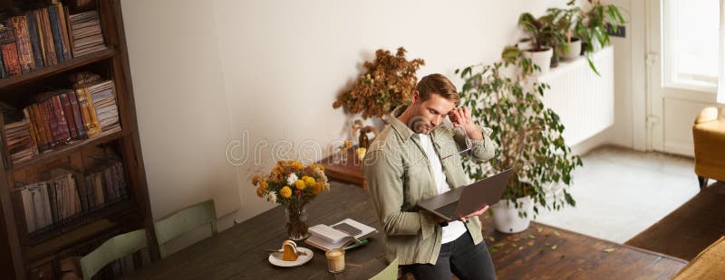 Image of Young Man, Successful Businessman Sitting on Table, Looking at ...