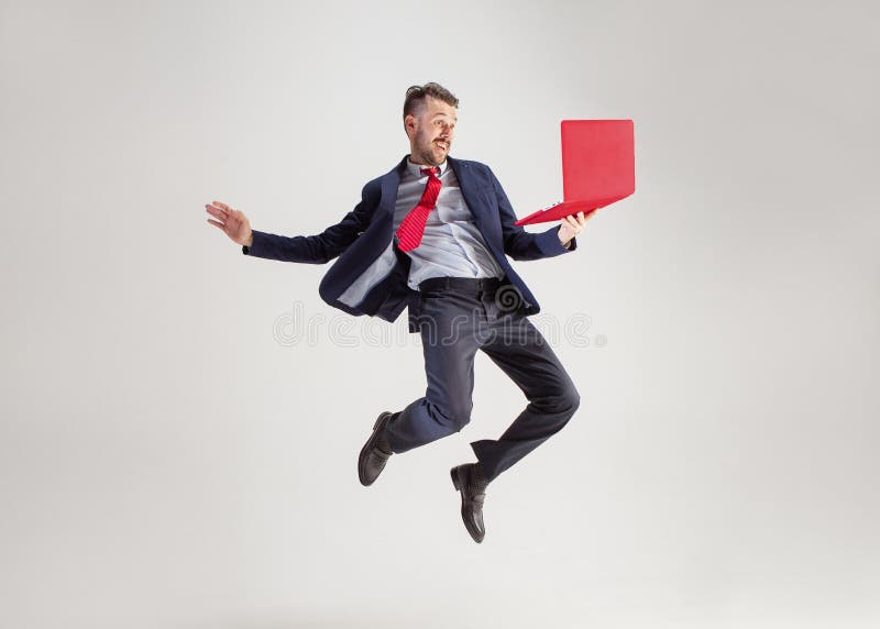 Image of Young Man Over White Background Using Laptop Computer while ...