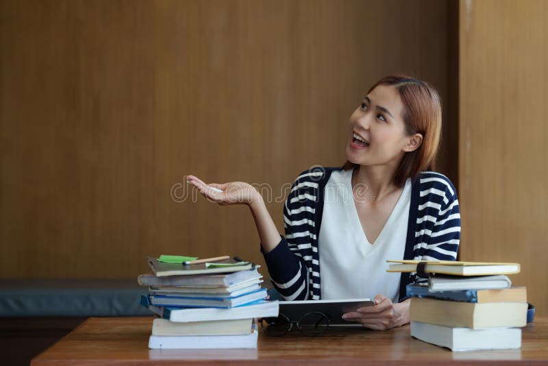Image of Young Woman Reading a Book for Exam at Library at School. Back ...