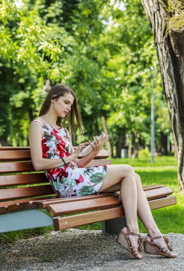 Young Woman with a Tablet in a Park Stock Image - Image of reading ...