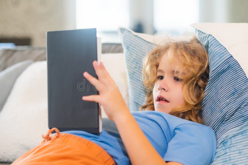 Imagination Child. Kid Boy Reading Book at Living Room. Stock Photo ...