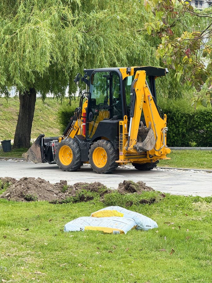 Construction Site with Backhoe Loader and Soil Bags Stock Image - Image ...