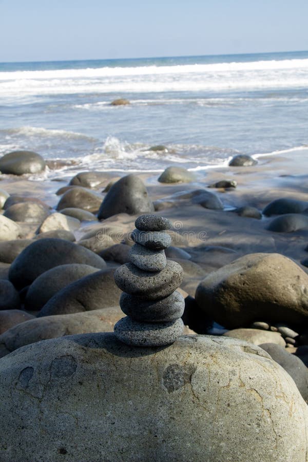 Stacked Stone Cairn on a Rocky Beach with Ocean View Stock Photo ...