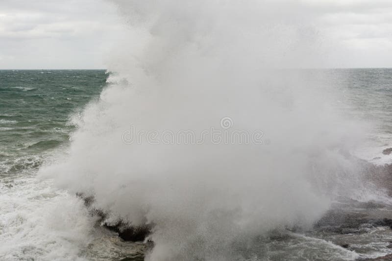 Immense Waves Hitting a Large Rock at the Edge of the Beach. Force of ...