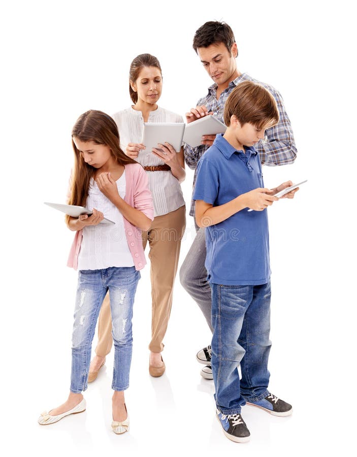 Immersed in the Online World. a Family of Four All Using Tablets while ...