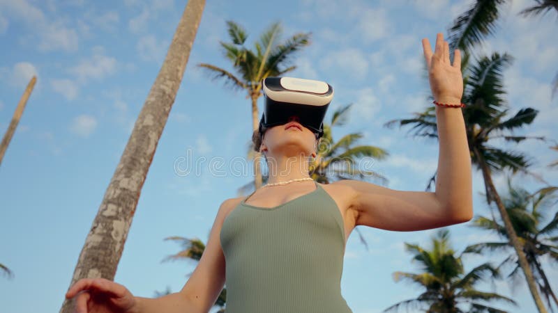 Woman Explores Virtual Realm Using VR Headset Amidst Palm Trees ...