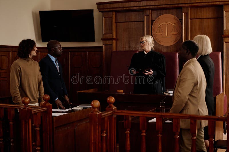 Defense and Prosecution Sides of Court Case Standing in Front of Judge ...