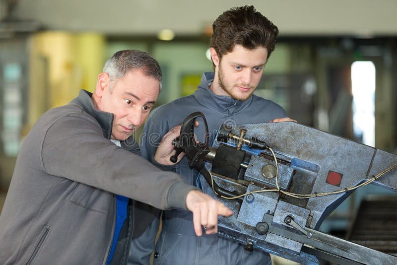 Impatient Man Pointing Where Apprentice Needs To Direct Machine Stock ...