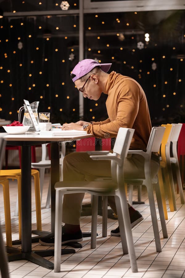Distantly Mulatto Man Working Hard at Laptop in Diner. Stock Image ...