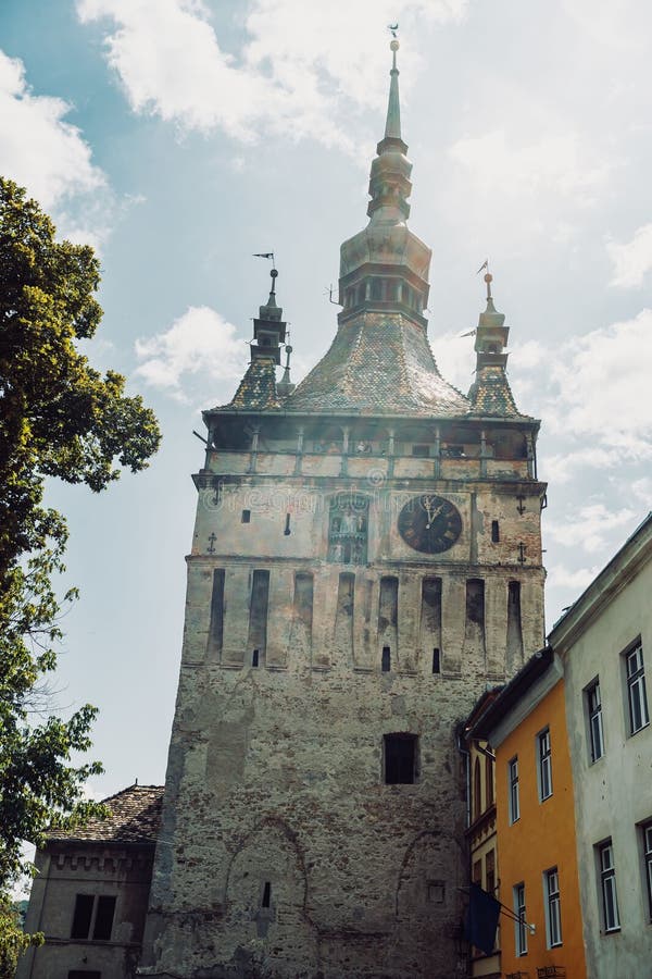 A Tall Brick Building with Several Windows and a Tower on the Side ...
