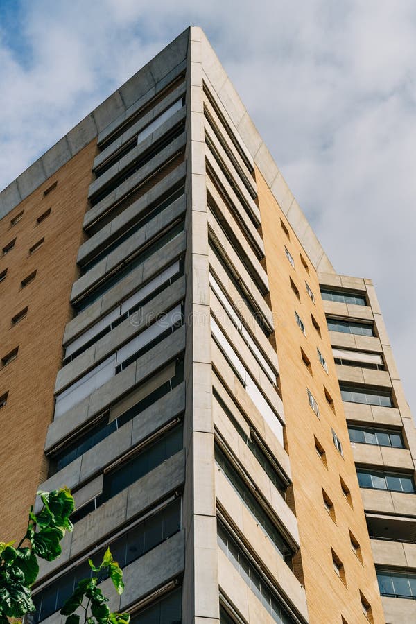 Imposing Building Rising Towards a Blue Sky with Clouds. Architecture ...