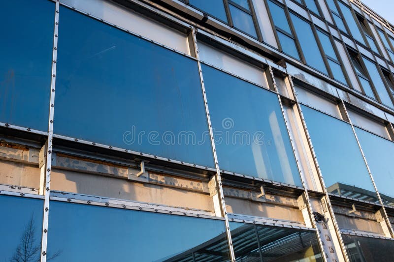 Imposing Large Building with a Modern Facade Featuring Blue Glass ...