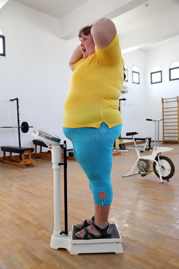 Impressed Overweight Woman on Scales in Gym Stock Photo - Image of ...