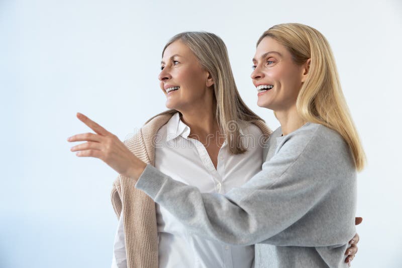 Two Women Discussing Something and Looking Impressed Stock Photo ...