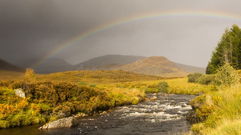 A rainbow over a river stock image. Image of united - 129757041