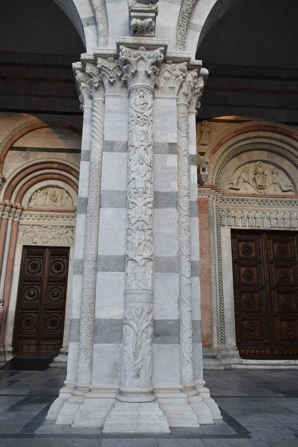 An Ornate Building with Columns and Doors in a Courtyard with Stone ...