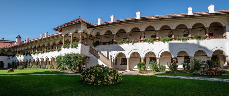 A Large Brick Building Has Several Arches and Balconies on Each Side ...
