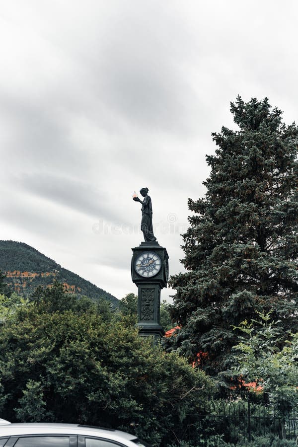 Impressive Clock Tower and a Figure, Set Against a Backdrop of Majestic ...