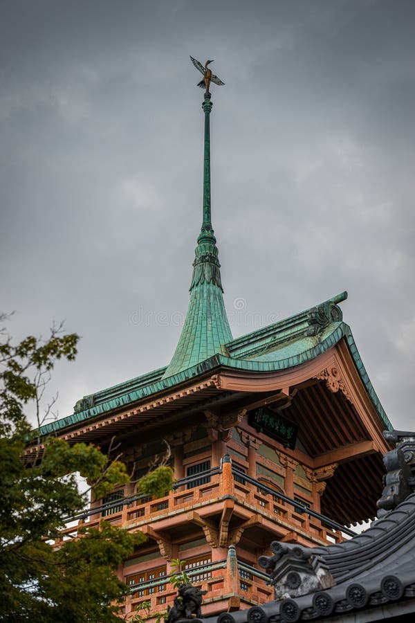 An Ornate Copper and Green Building with a Bell and a Statue in the ...