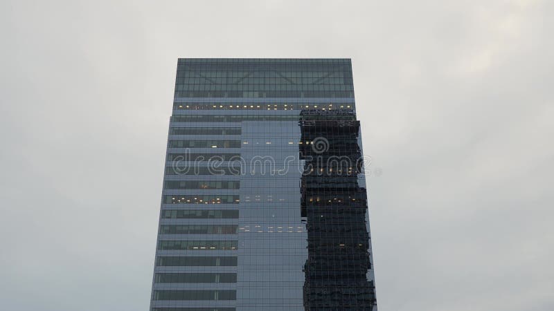 A Modern Skyscraper Rises Elegantly Under the Backdrop of a Cloudy Sky ...