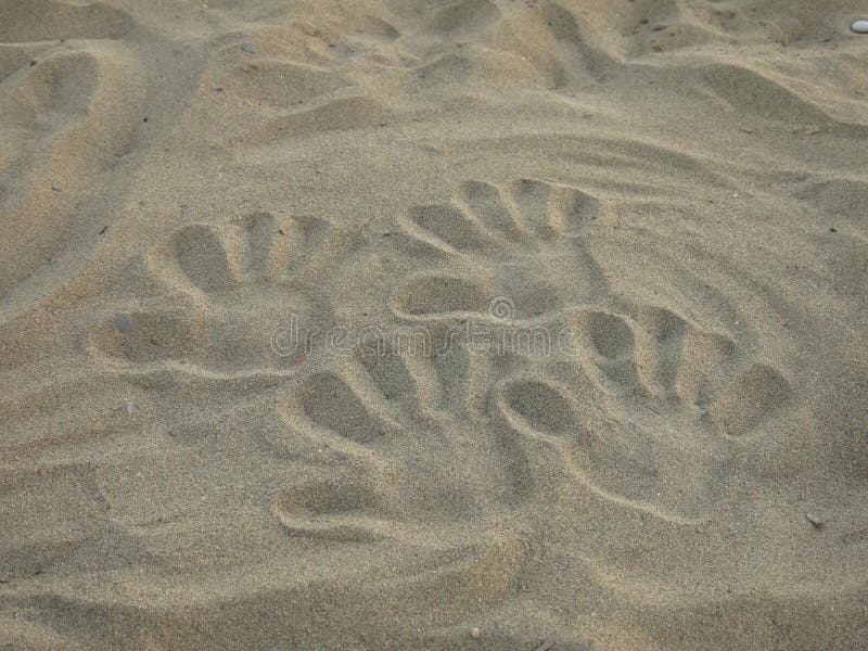 Imprint of Four Hands in the Sand Stock Image - Image of hands, imprint ...