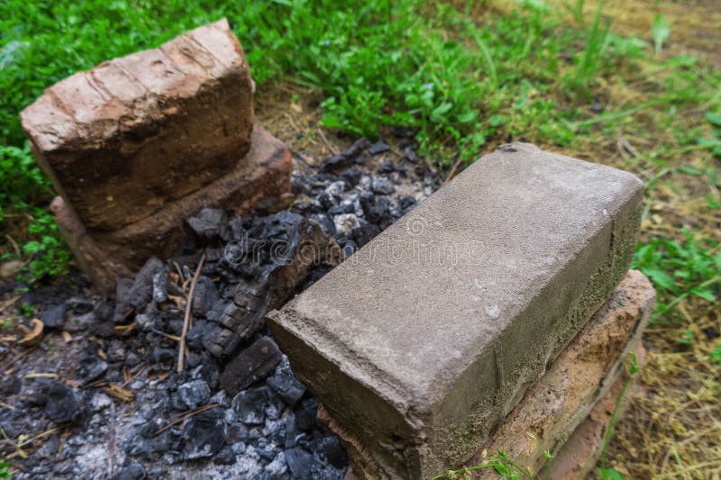 Improvised Restrictive Fire Pit Grill Made of Multiple Bricks To Cook ...