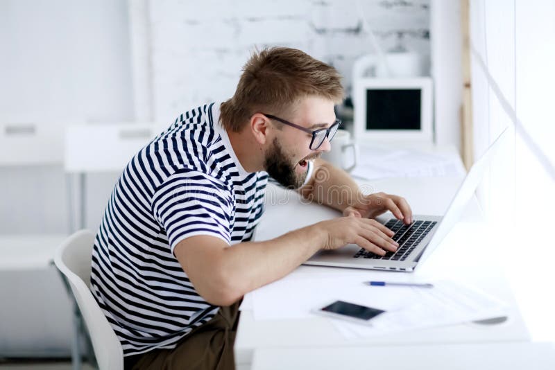 Impulsive Man with Open Mouth Looks into the Laptop in the Office ...