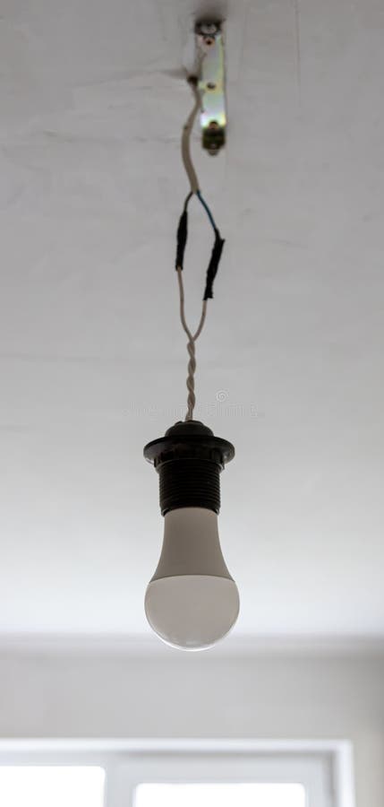 An Incandescent Lamp on the Ceiling, an Old Non-working Lamp with a ...