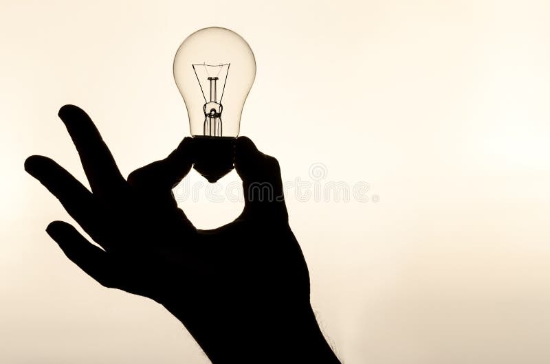 Incandescent lamp in hand stock photo. Image of glass - 114507876