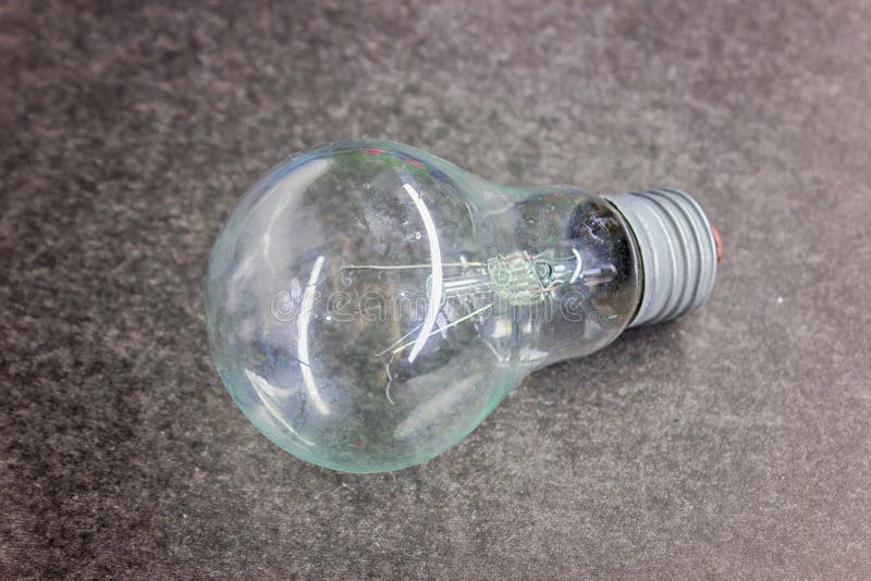 Incandescent Light Bulb on a Dark Gray Background Close-up. Stock Image ...