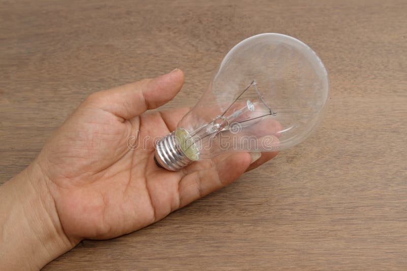 Incandescent Light Bulb in Hand Stock Photo - Image of illuminated ...