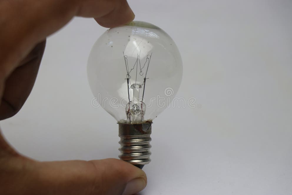 Incandescent Light Bulb Held in the Hand on White Background Stock ...
