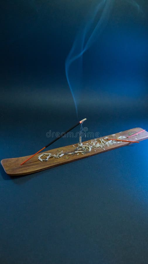 Incense with Smoke in a Small Wooden Table. Black Background Isolated ...