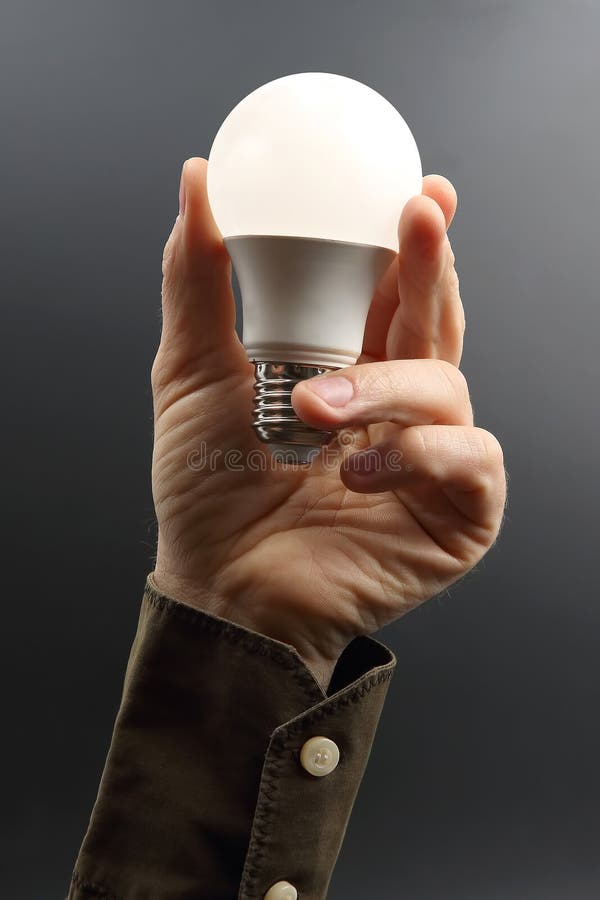 Included Led New Lamp in Human Hand on Dark Background Stock Image ...