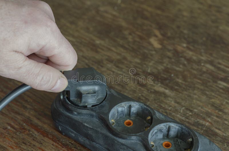 Hand Disconnects or Connects the Plug To a Broken Outlet, Risk of ...