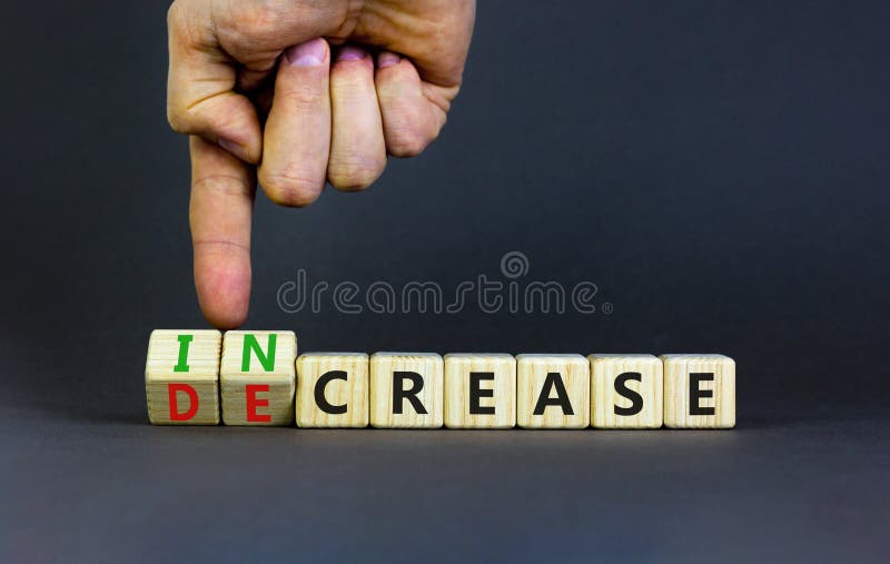 Increase or Decrease Symbol. Concept Words Increase and Decrease on Wooden Cubes. Businessman ...