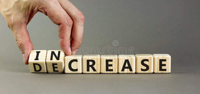 Increase or Decrease Symbol. Concept Words Increase and Decrease on Wooden Cubes. Businessman ...