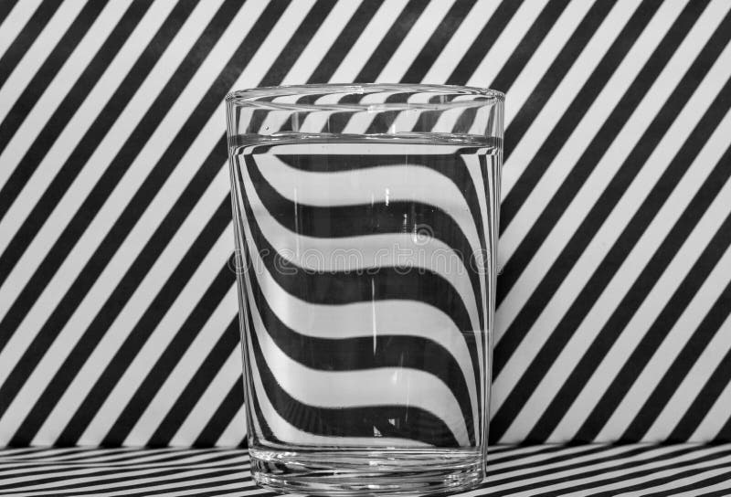 Incredible Effect of Water on Straight Lines. Glass of Water on a ...