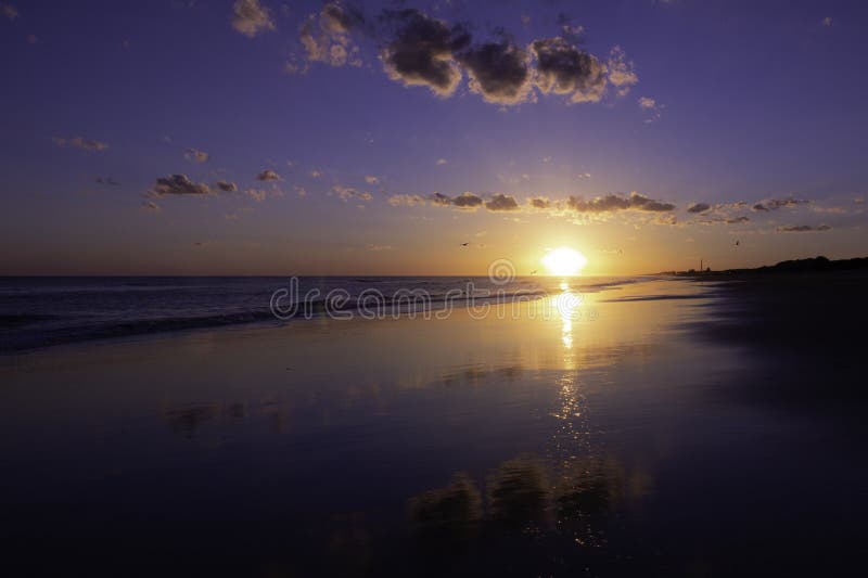 Incredible Sunset on the Beach. the Sun is Reflected in the Water Like ...