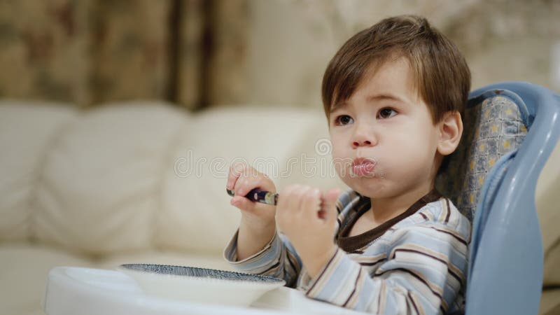 Independent Kid of Two Years Eats Dumplings. Side View Stock Video ...