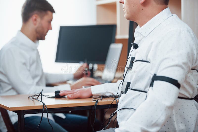 Sitting on the Black Chair. Polygraph Examiner Works in the Office with ...