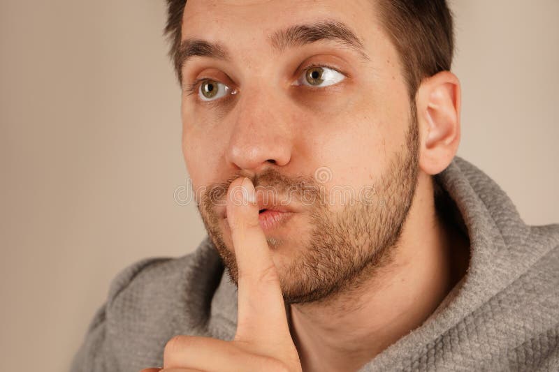 With an Index Finger Pressed To His Lips, the Man Requests Silence in a ...