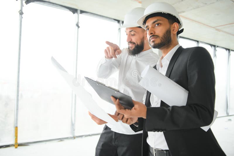 Indian and Arabian Engineers. Contractor and Architect Talking about ...